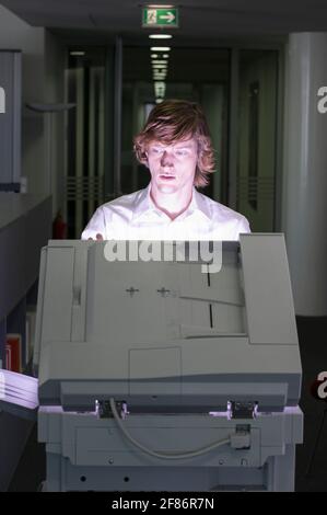 Businessman making copies in copying machine Stock Photo - Alamy