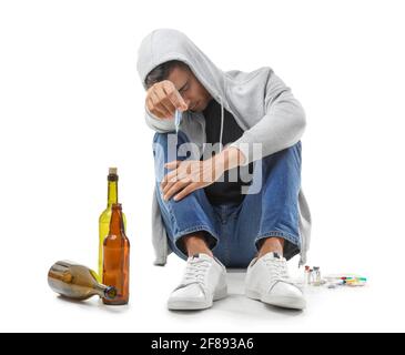 Male junkie with drugs and alcohol on white background Stock Photo - Alamy