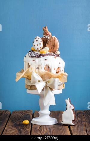 Easter concept background with cake and decor eggs on minimal blue ...