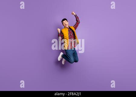 Photo of cute lucky guy dressed grey shirt sitting bean bag typing ...