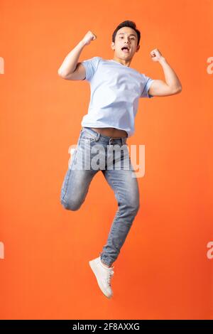 Asian man jumping and shouting Stock Photo - Alamy