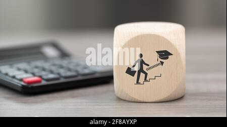 Wooden block with symbol of continuing education concept Stock Photo ...