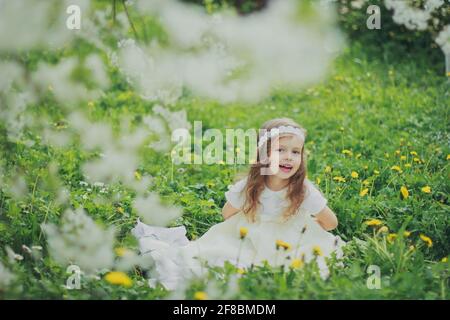 Little child is hiding something behind her back Stock Photo - Alamy