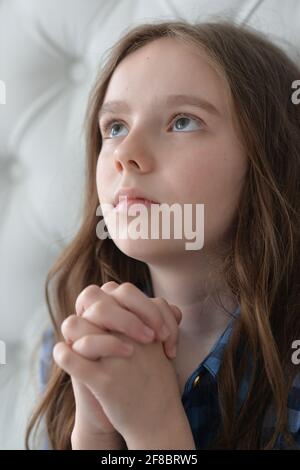 Cute girl praying isolated on white background Stock Photo - Alamy