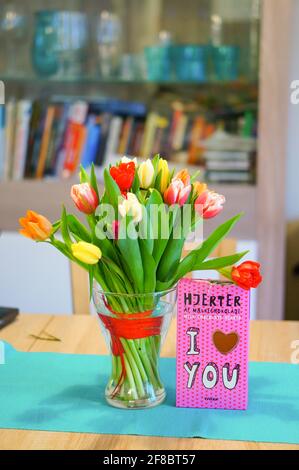 POZNAN, POLAND - Feb 18, 2016: Bunch of tulips and chocolate in box ...