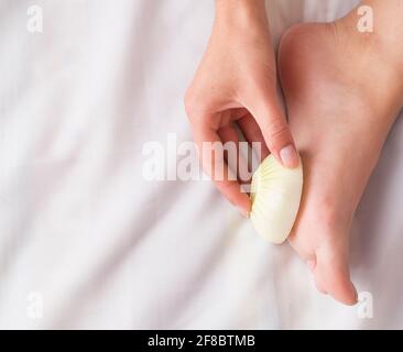 Home onion remedy on the feet to detoxify Stock Photo - Alamy