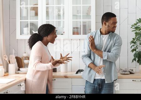 Upset and angry woman with PMS and husband calms and hugs her, provides ...