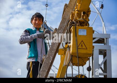 Kazakhstan, Shardara water storage dam. Group of Uzbek workers mixing ...