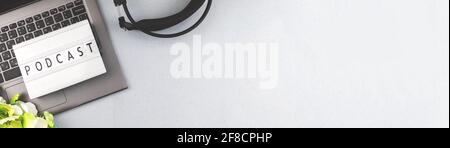 Podcast word on lightbox, headphones, vintage microphpne and cup of ...