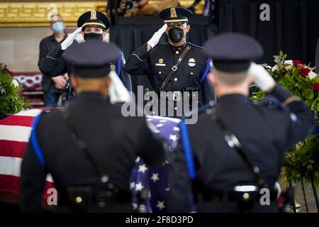 Members of law enforcement salute the casket during the processional at ...
