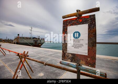 A danger loading dock sign and a no entry sign on a brick ball near a ...
