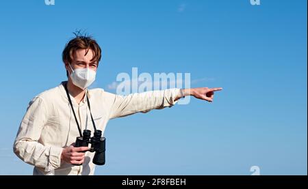 Side view of a Spanish male tour guide wearing a facemask showing the ...