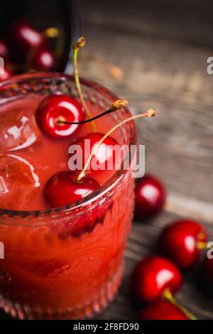 Old fashioned cherry cocktail with berries. Selective focus. Shallow ...