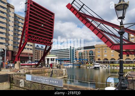 The drawbridge being raised at the lock in St Katharine Docks Marina ...