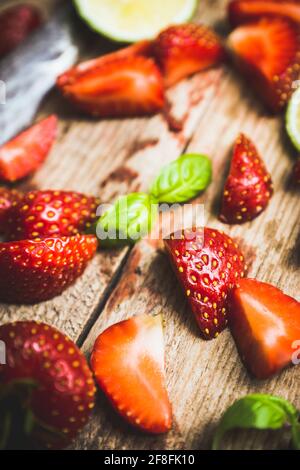 Ingredients for cocktail with strawberry and basil leaves. Selective ...