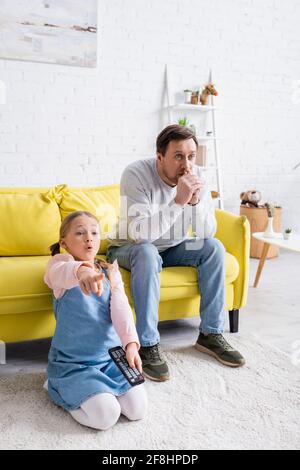 Surprised man pointing to copy space. White background, Medium shot ...