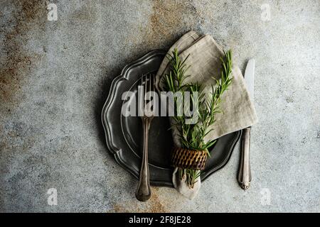 Table setting with fresh rosemary on dark stone table with copy space ...