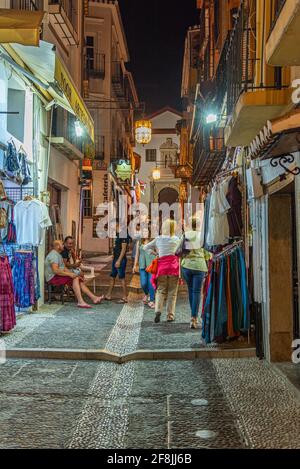 GRANADA, SPAIN, JUNE 21, 2019: Nightlife in a narrow street in Albaicin ...