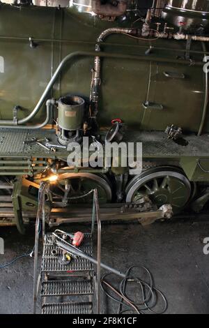 Maintenance work on the historic steam locomotive, Treno Natura, black ...