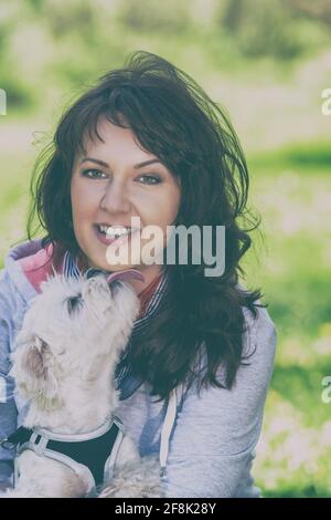 Woman dog puppy lick smile face pet outdoor grass affection, young ...