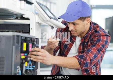 middle age man fixing a printer Stock Photo - Alamy