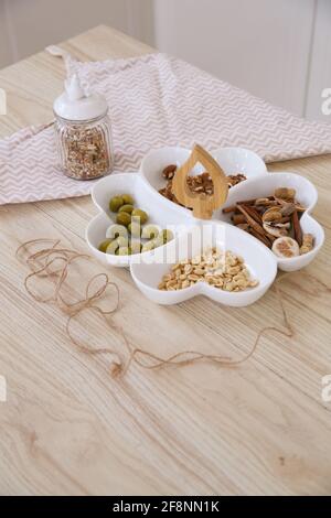 A festive plate served with nuts and other snacks in a bright ...