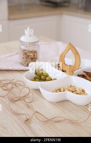 A festive plate served with nuts and other snacks in a bright ...