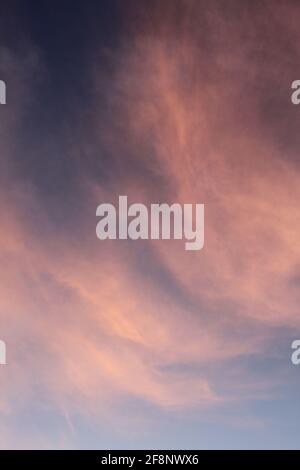 Vertical shot of fluffy pink clouds in the sky Stock Photo - Alamy