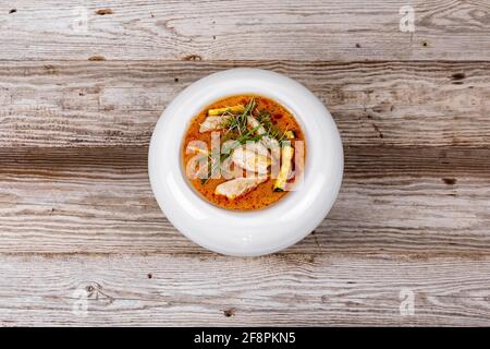 Tom yum soup and ingredients on dark wooden background Stock Photo - Alamy
