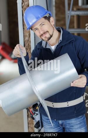 Plumber hands holding PVC pipe connect drain water in new building ...