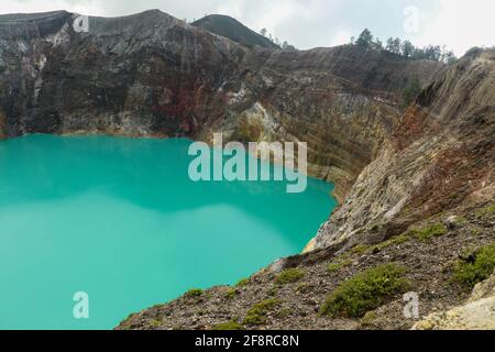 Adjacent green and red volcanic lakes of the famous tri-color - three ...