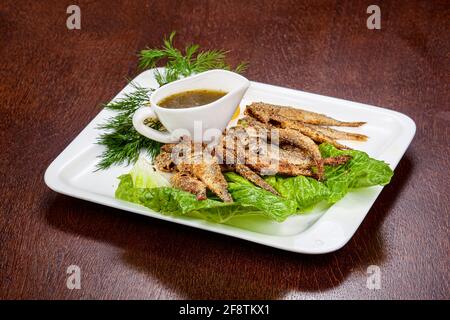 Fried barabulka fish snack with sauce Stock Photo - Alamy