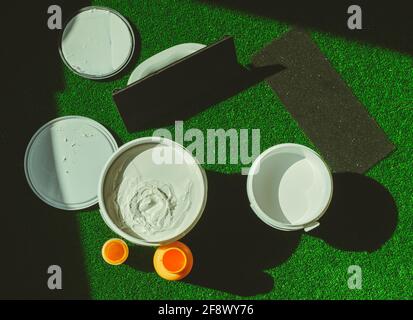 Water-based paint repair concept. yellow paint on artificial grass ...