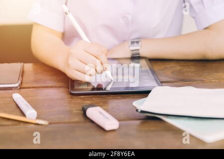 Schoolgirl Using Digital Tablet Taking Notes Learning Online At Home ...