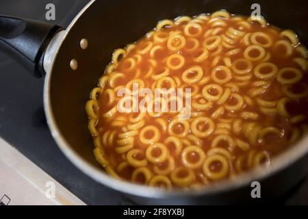 Tinned spaghetti hoops cooking in a pan on an electric hob Stock Photo ...