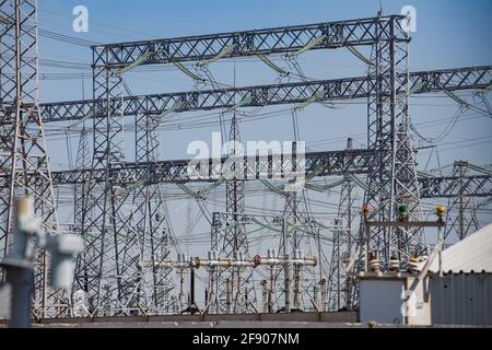Electricity distribution substation. Pylons and cables. Blue sky ...