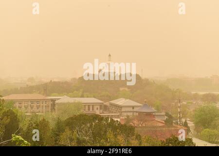 Beijing, China. 15th Apr, 2021. A cyclist seen riding his bike through ...