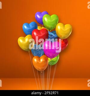 Colorful heart shape balloons bunch on a white wall background ...