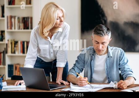 Successful senior businesspeople working together in modern office ...