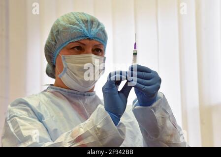 A healthcare worker prepares a dose of Sinovac COVID-19 vaccine during ...