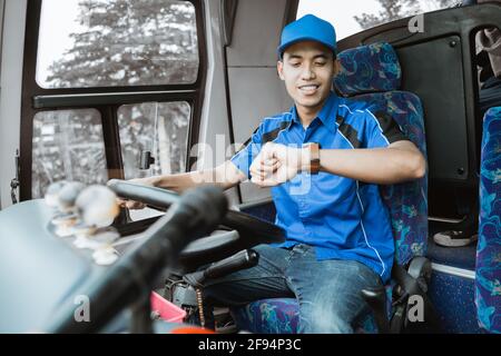 Driver man looks at his watch while driving. Transport security Stock ...