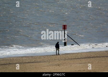 Pakefield Beach, Lone man walking Stock Photo - Alamy