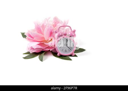 delicate pink alarm clock on the background of a light-permeable sleep ...