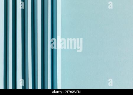 Abstract light blue colored paper texture. Folded paper with harsh sun ...