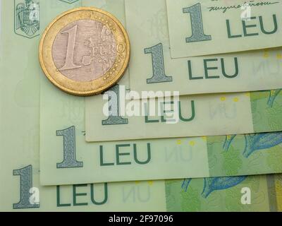 One euro coin put on Romanian banknotes of one leu background Stock ...