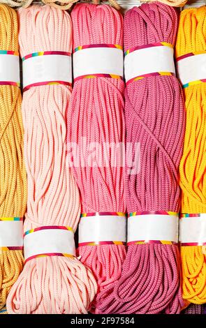 Rolls of polyester cord in various vibrant colors of green, brown and ...