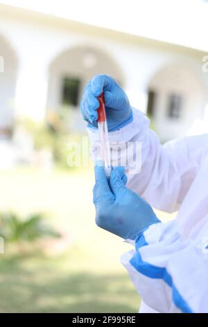 A closeup of a doctor putting a swab in a test tube Stock Photo - Alamy
