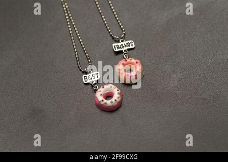 Pendant set of best friends two colors heart necklace shoot outside in ...