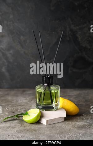 Citrus reed diffuser on dark background. Creating cozy atmosphere at ...
