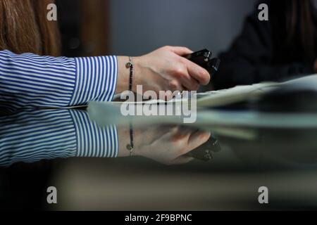 Female hands stapling documents with paper clip on desk in office ...